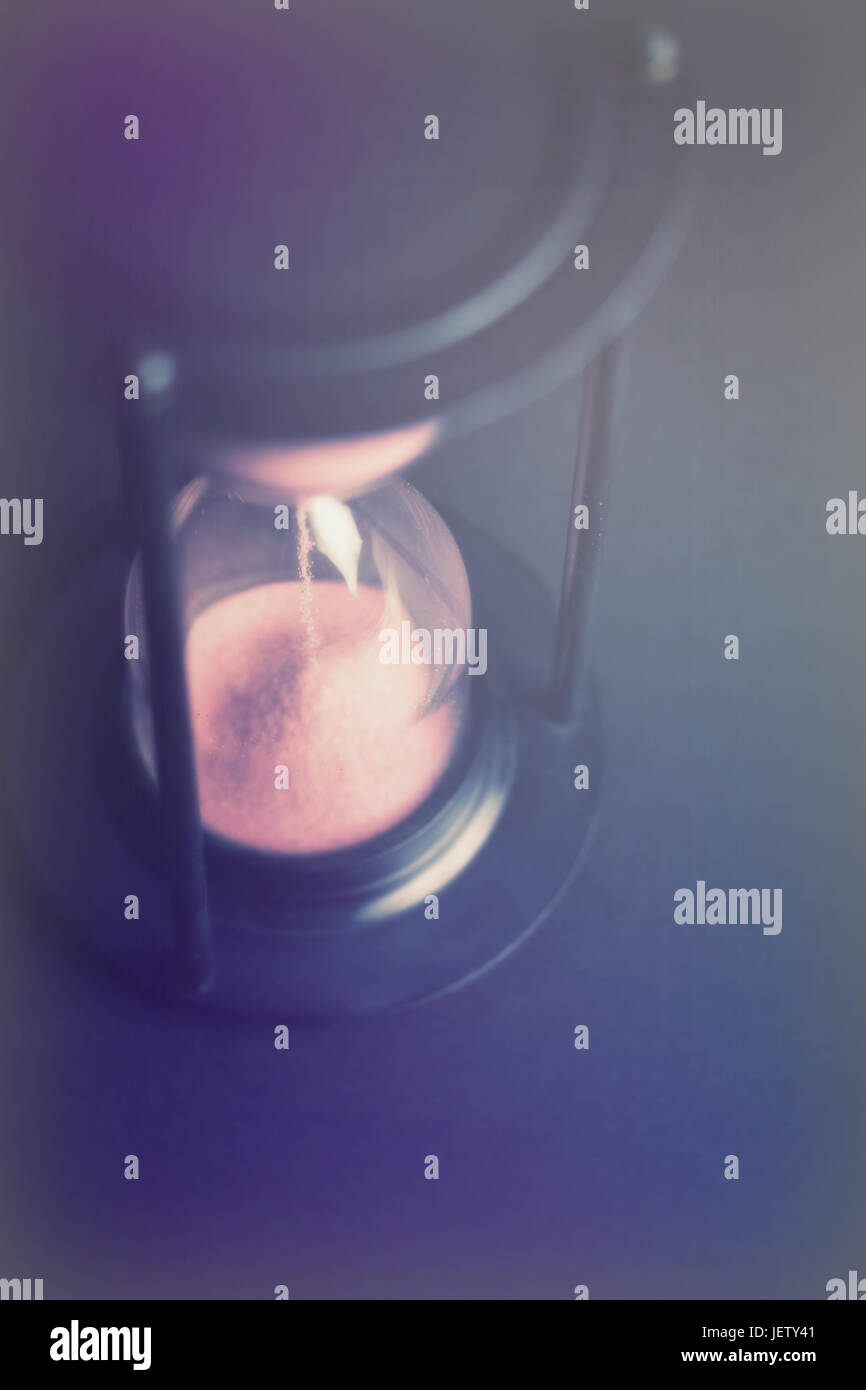 Large hourglass with pink sand against a black background Stock Photo ...