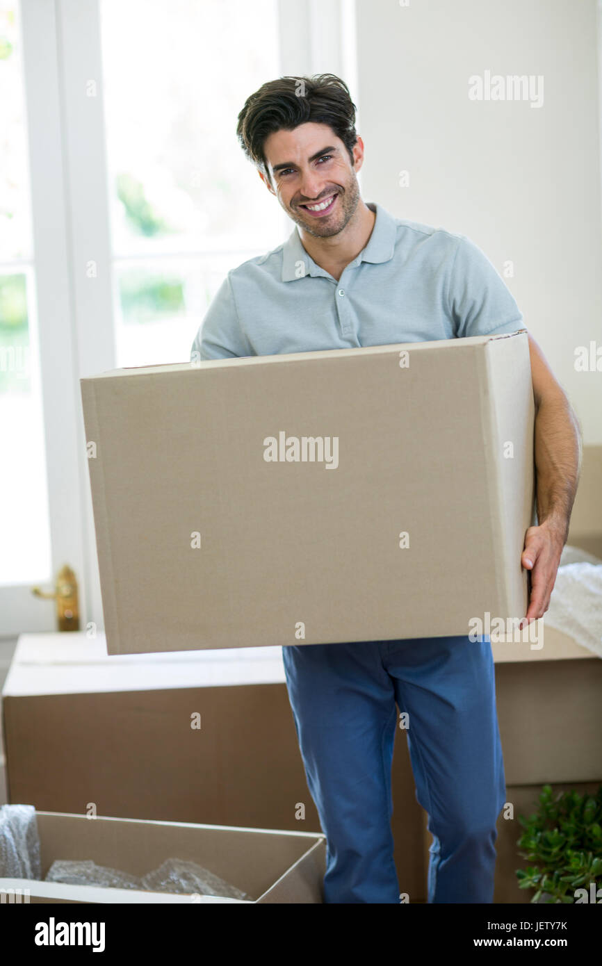 Young man carrying cardboard box Stock Photo - Alamy