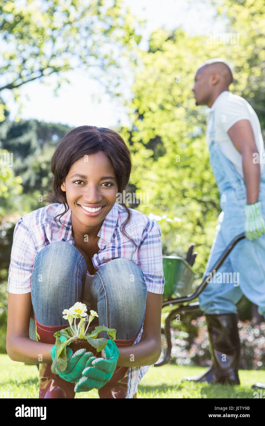Young woman holding a sapling Stock Photo - Alamy