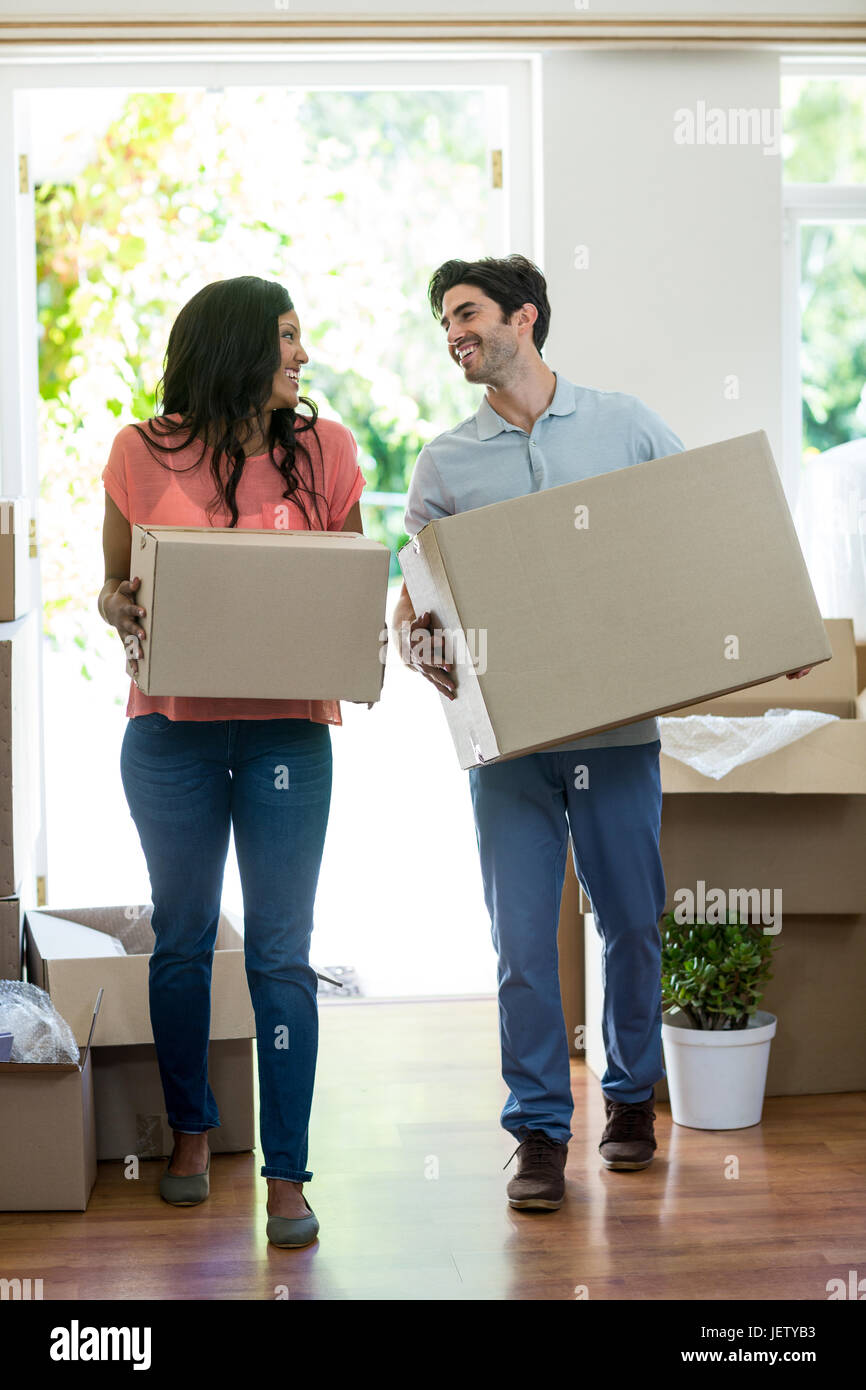 Young couple carrying cardboard box Stock Photo - Alamy