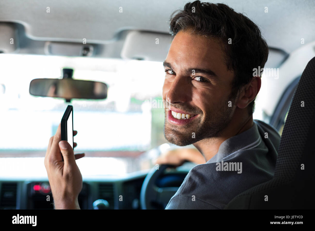 Driver using phone hi-res stock photography and images - Alamy