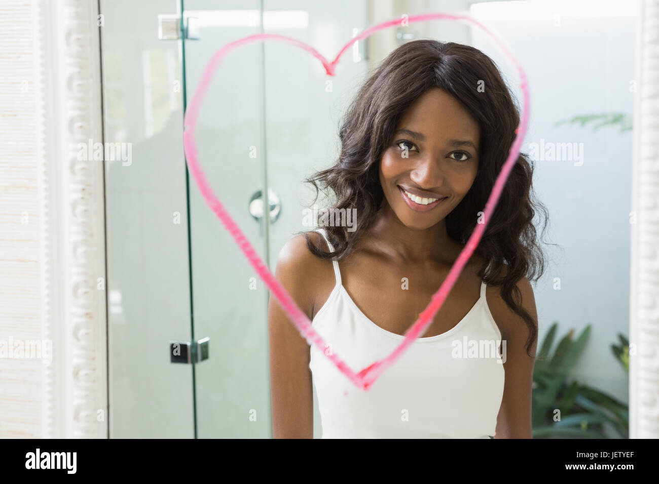 Beautiful young woman reflection in mirror Stock Photo - Alamy