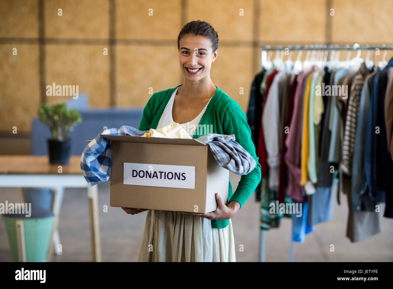 Young woman with donation box Stock Photo - Alamy