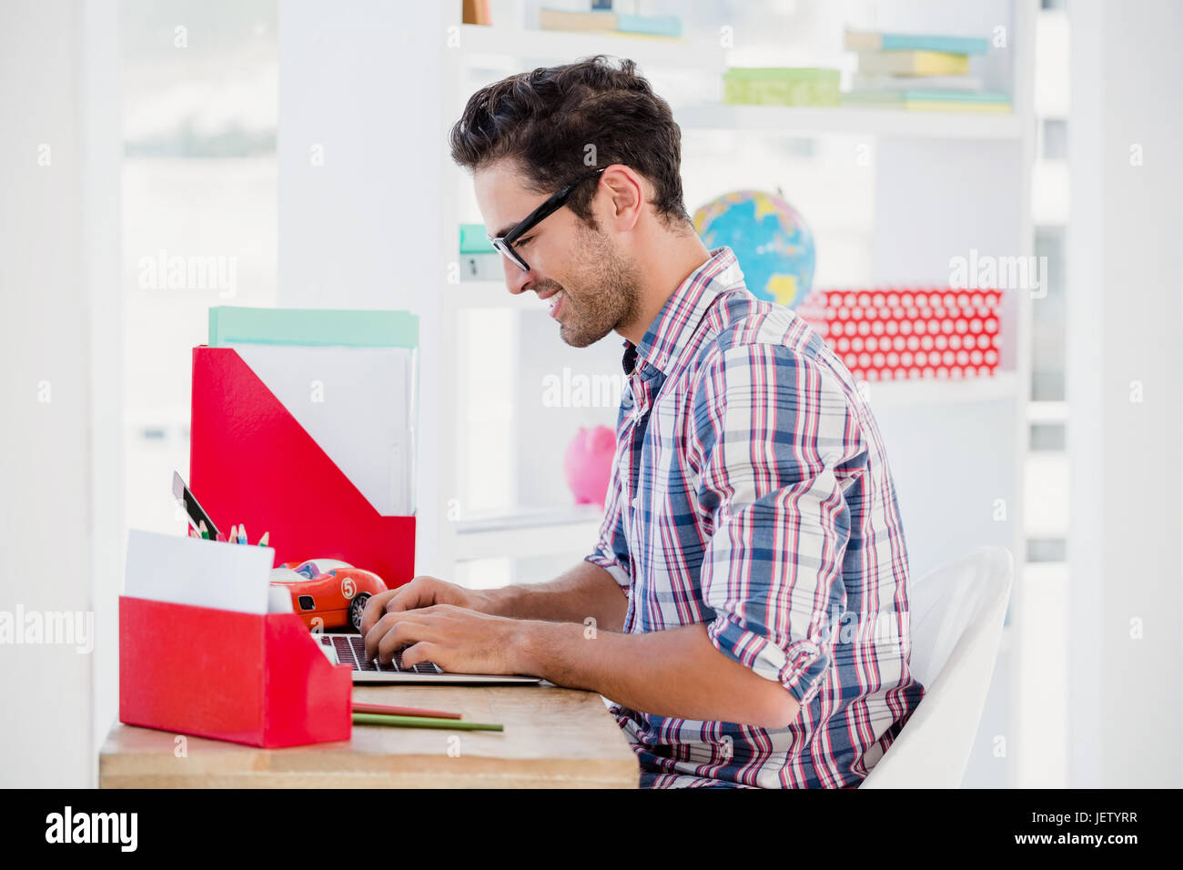 Young man working at his desk Stock Photo - Alamy