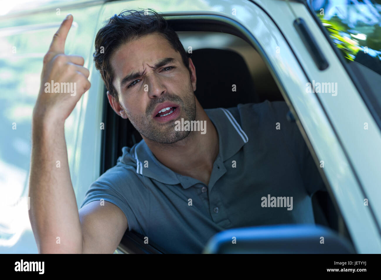 Portrait man pointing camera sitting hi-res stock photography and ...