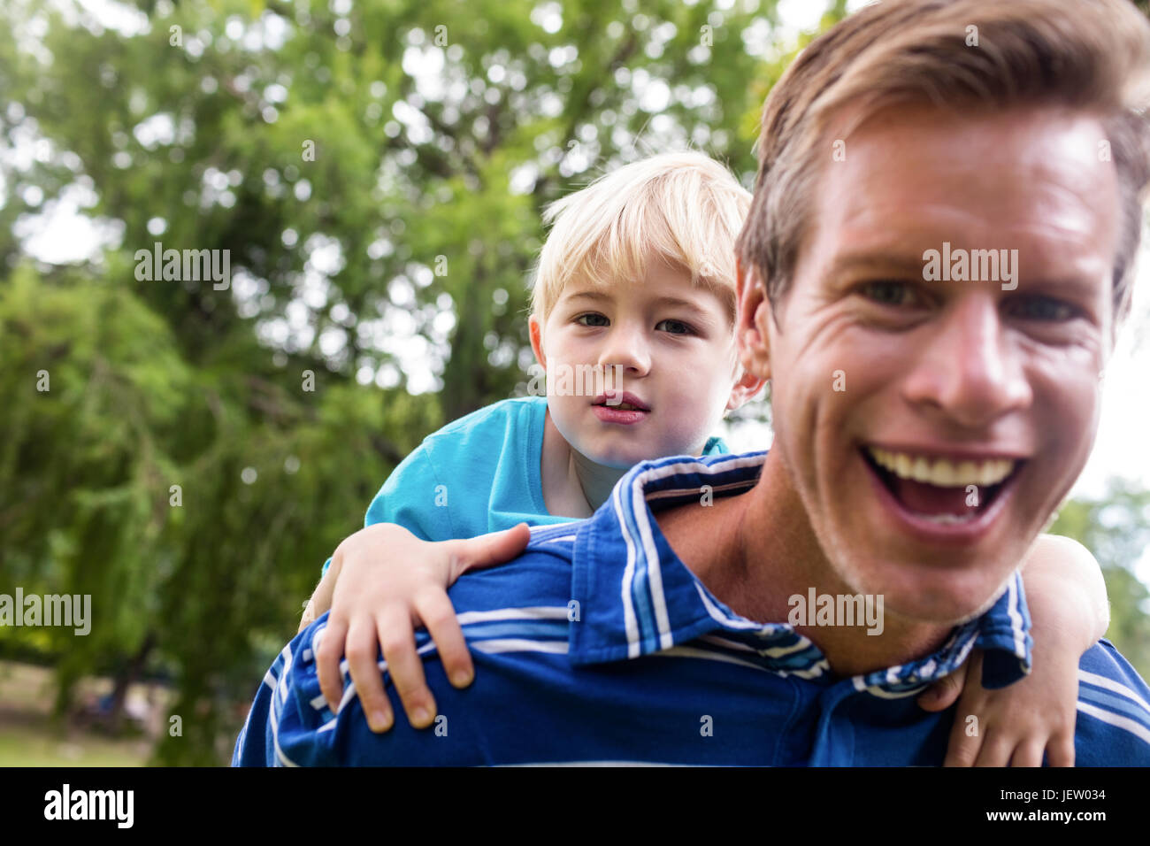 Happy man giving piggyback to his son Stock Photo - Alamy