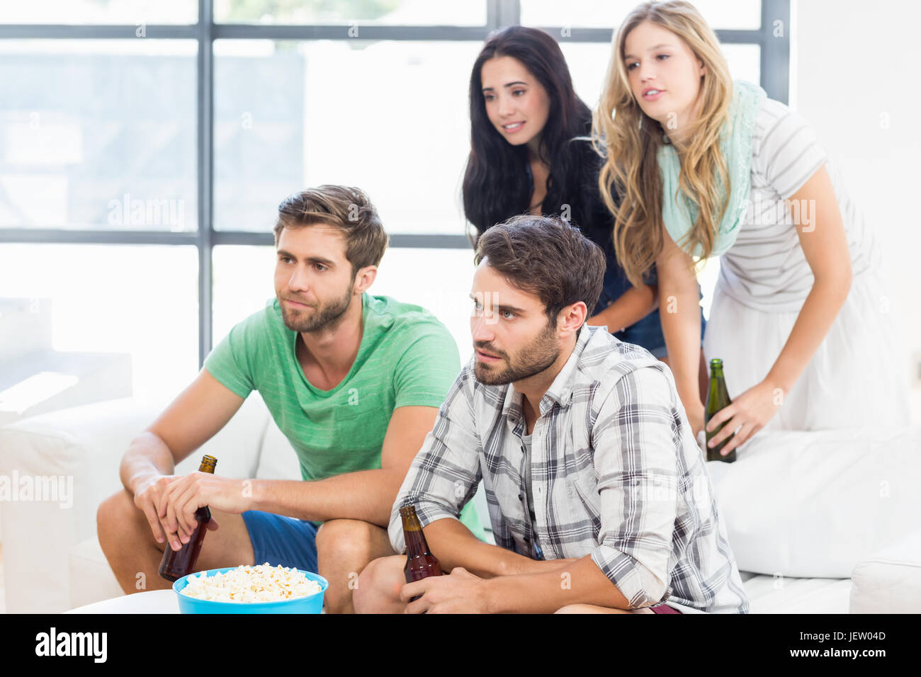 Disappointed supporters sitting on sofa Stock Photo - Alamy
