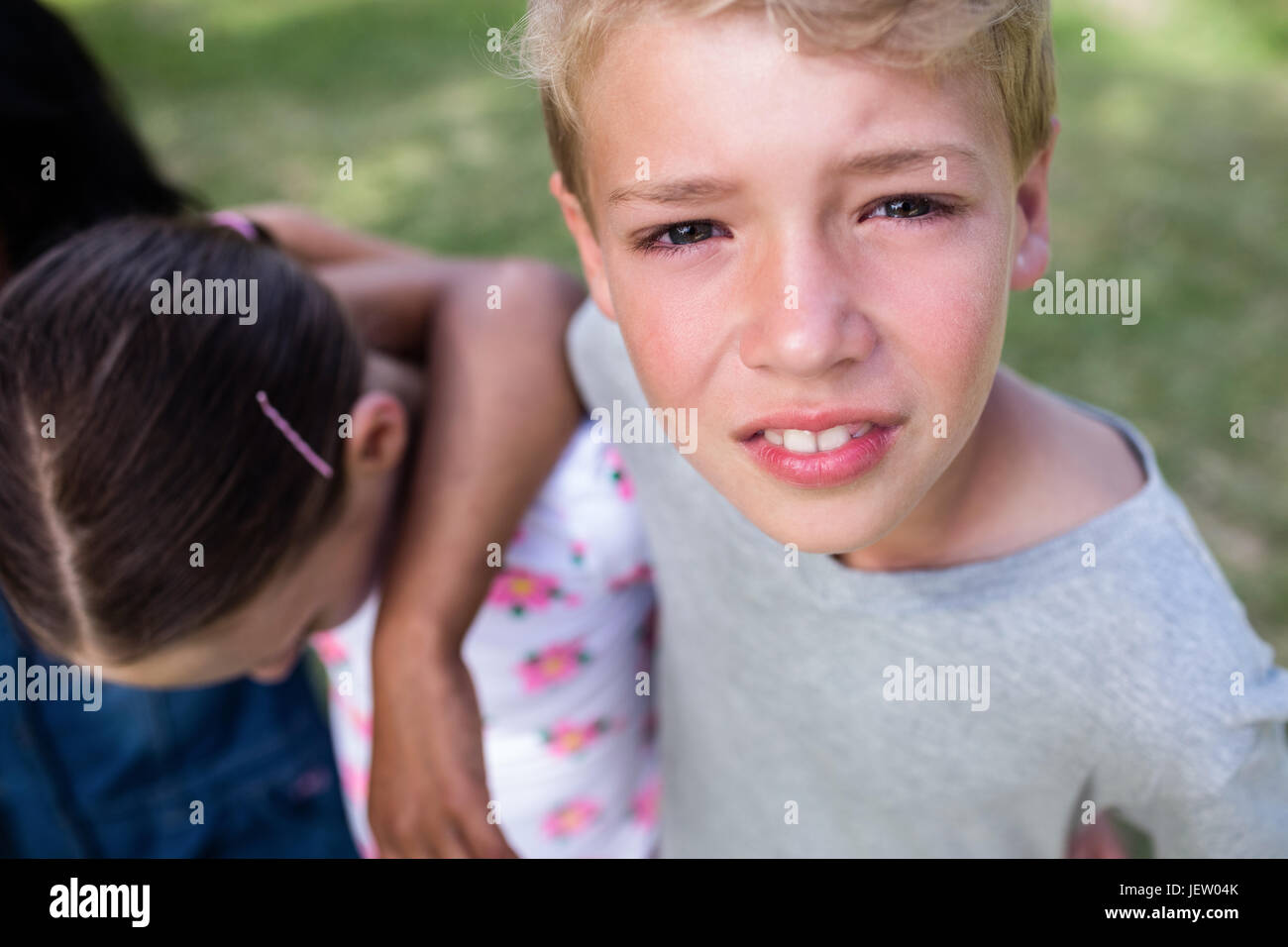 Happy boy standing in park Stock Photo - Alamy