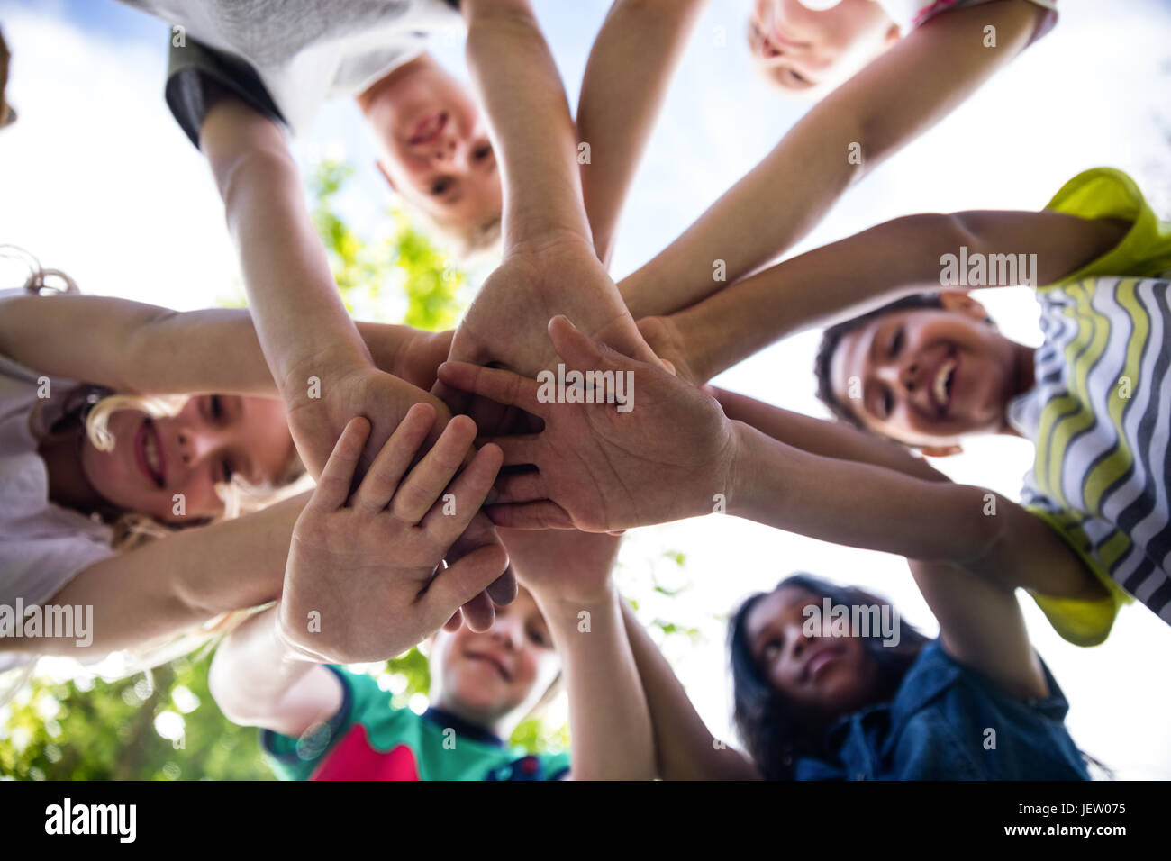 Children putting their hands together Stock Photo - Alamy