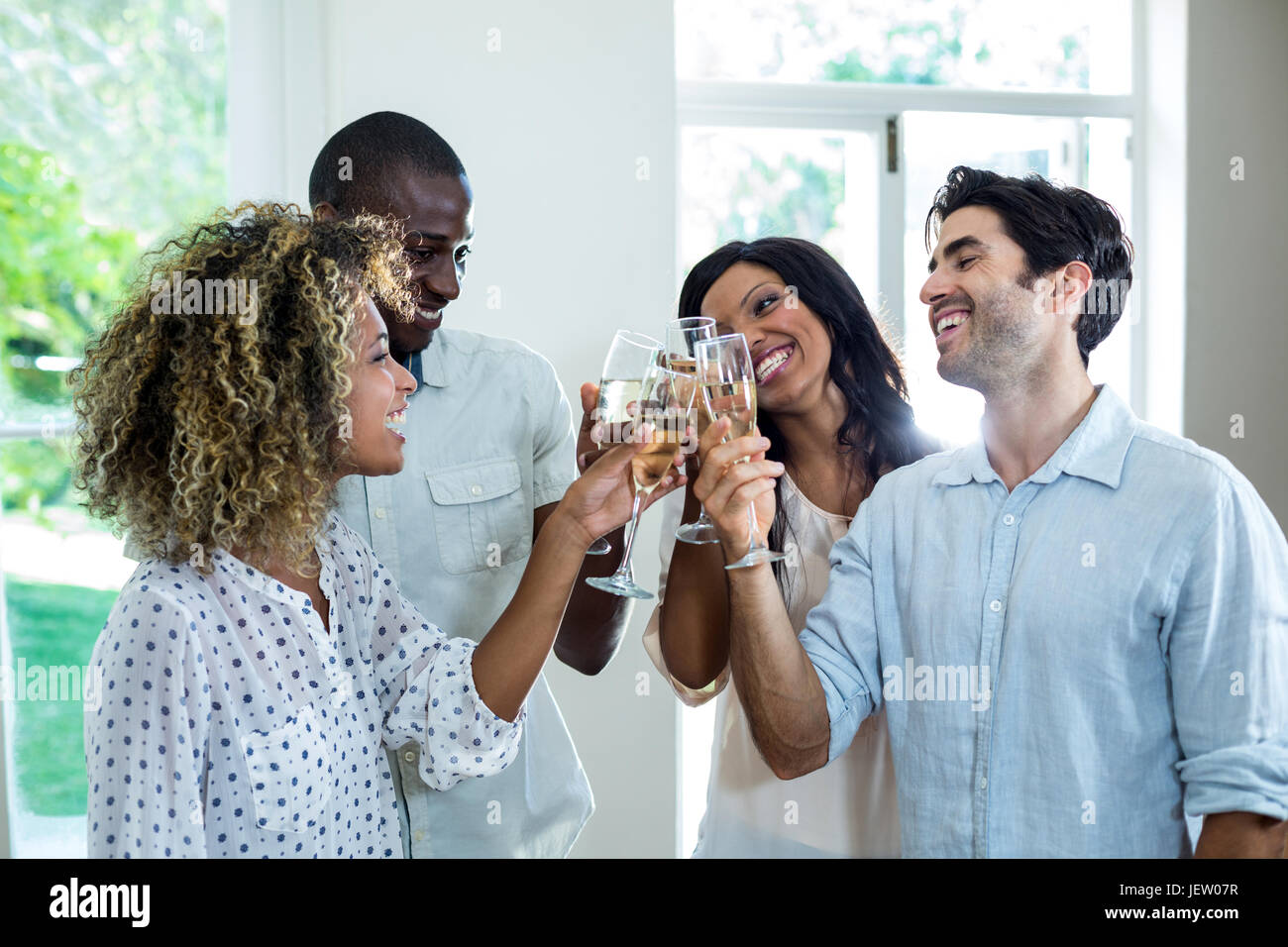 Happy friends toasting wine glasses Stock Photo - Alamy