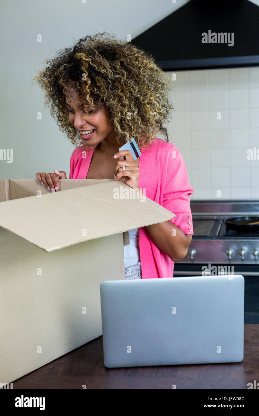 Happy woman looking into the parcel Stock Photo - Alamy
