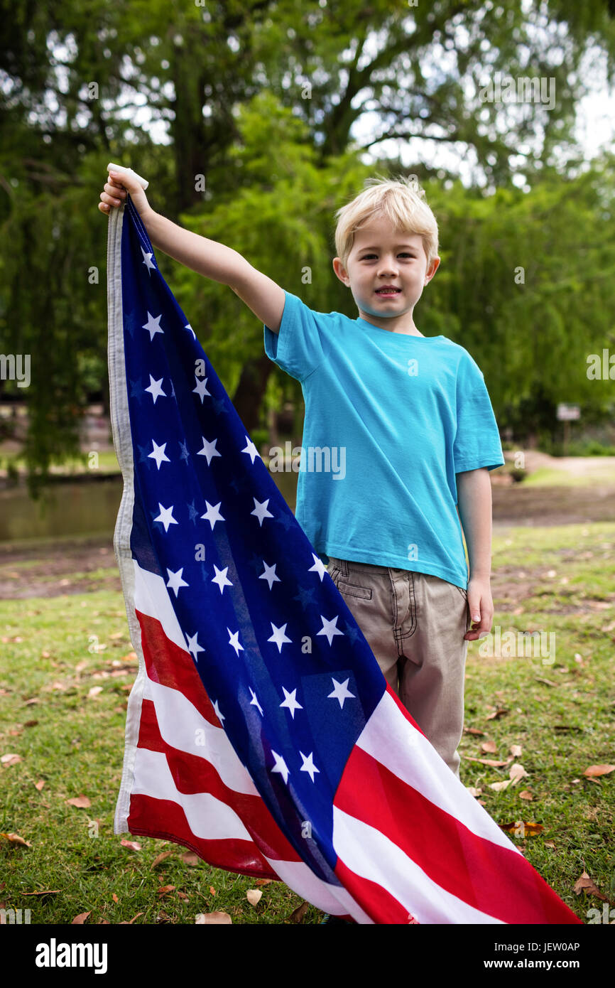Boy holding an american flag in the park Stock Photo - Alamy