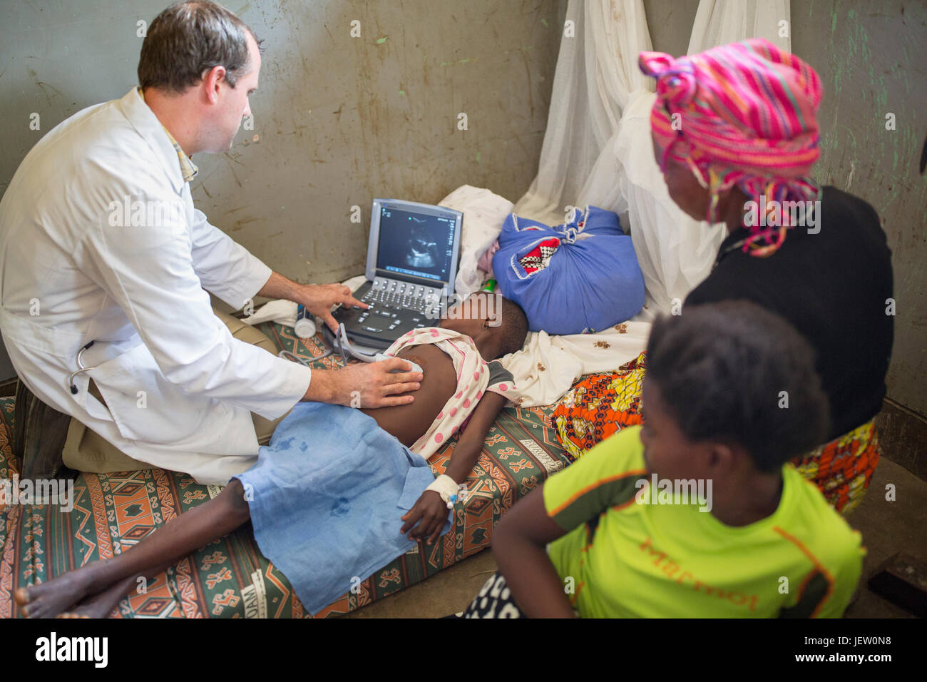 An expat missionary doctor uses a portable ultrasound kit at in ...
