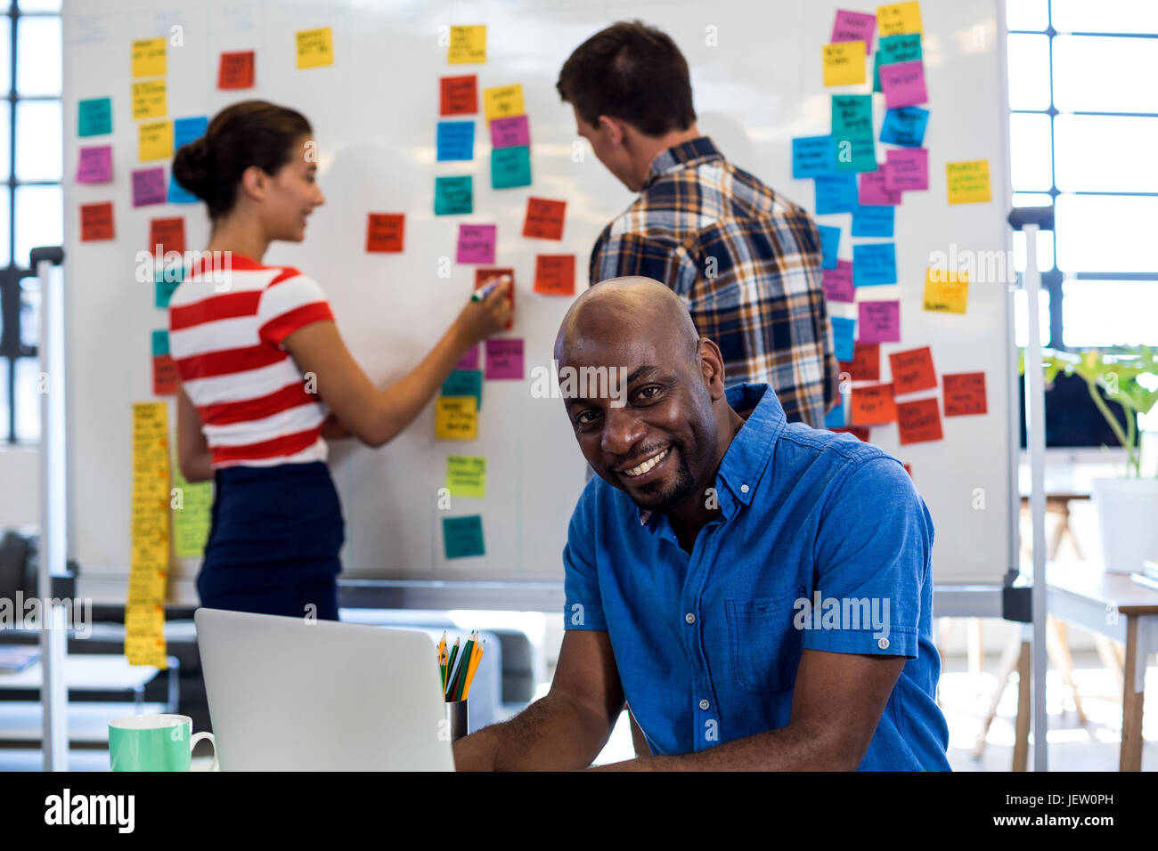 Cheerful graphic designer smiling camera hi-res stock photography and ...