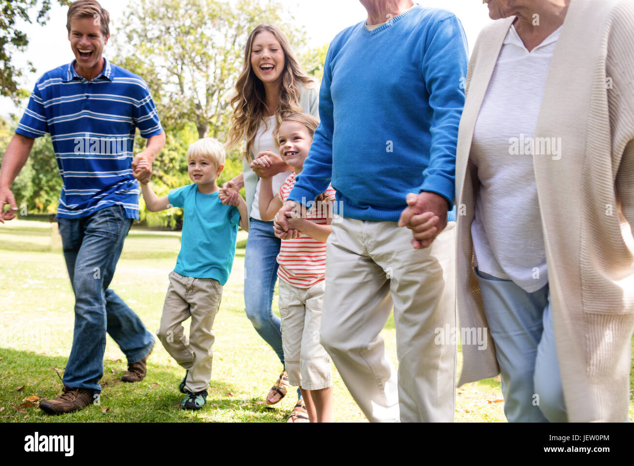 Multi-generation family walking in the park Stock Photo - Alamy
