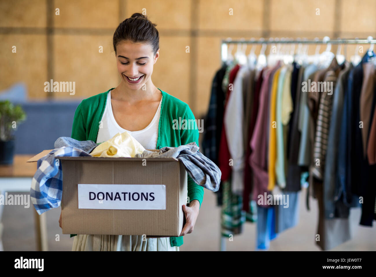 Young woman with donation box Stock Photo - Alamy