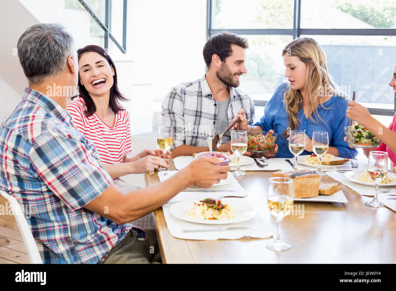 Friends interacting while having a meal Stock Photo - Alamy