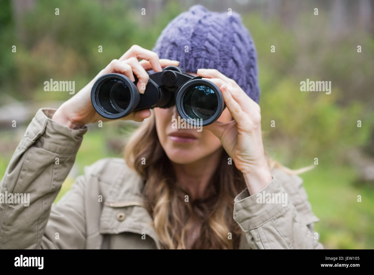 Woman using binoculars Stock Photo - Alamy