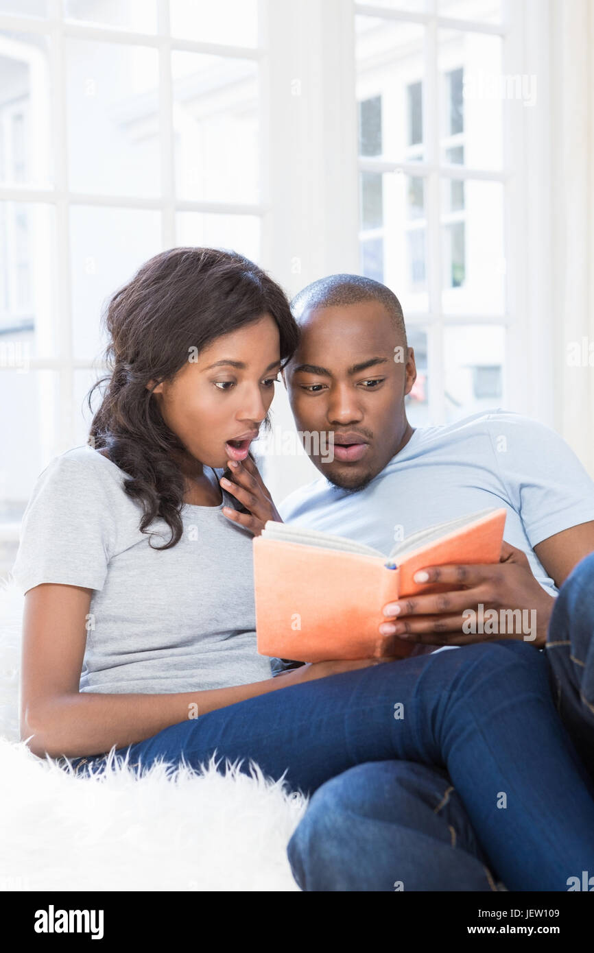 Young couple reading book Stock Photo - Alamy