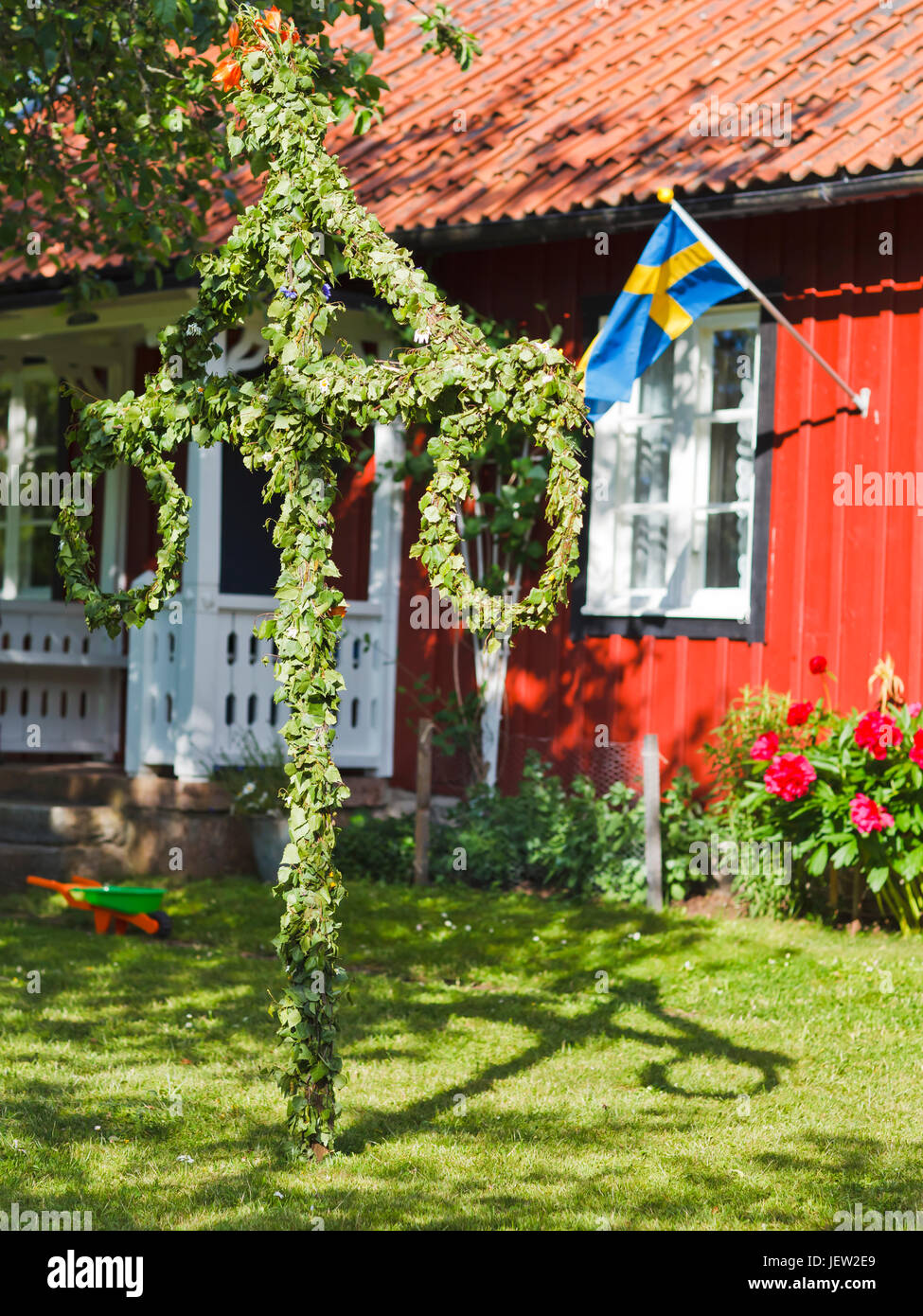 Maypole in front of wooden house Stock Photo - Alamy