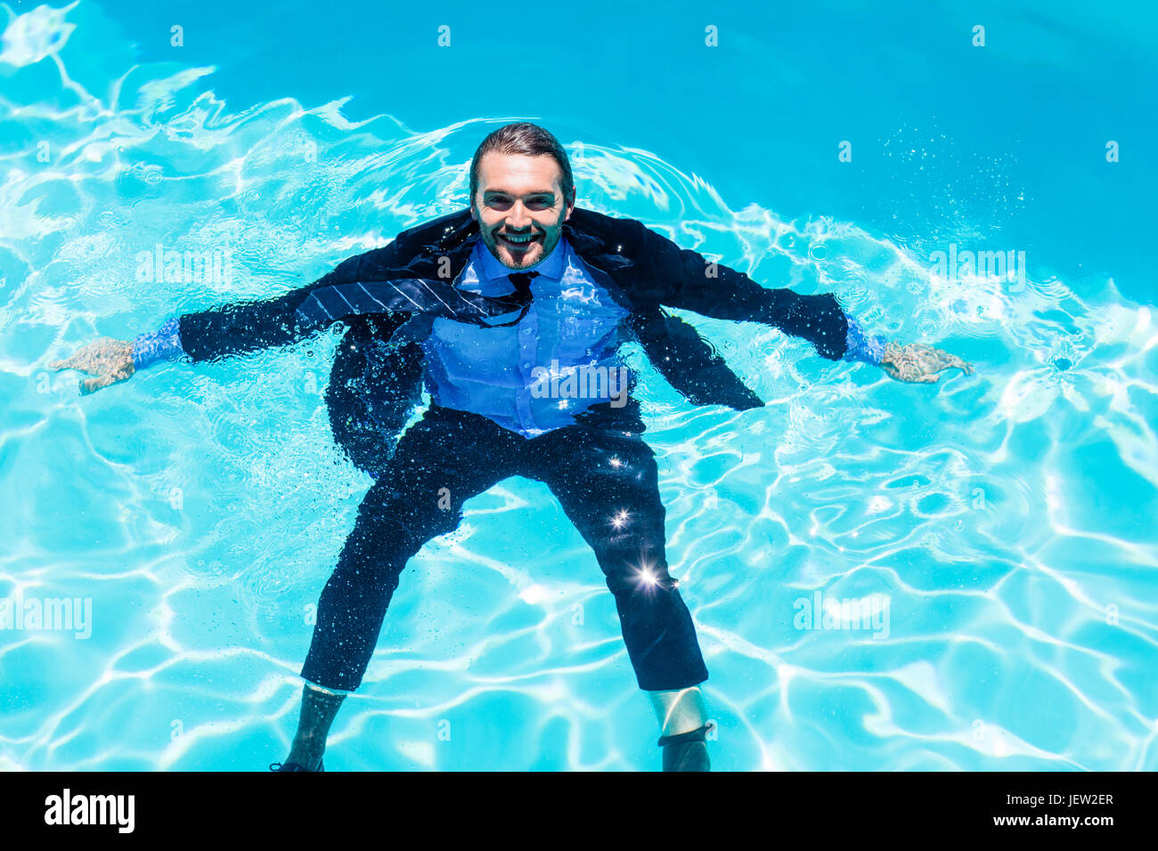 Dressed businessman in swimming pool Stock Photo - Alamy