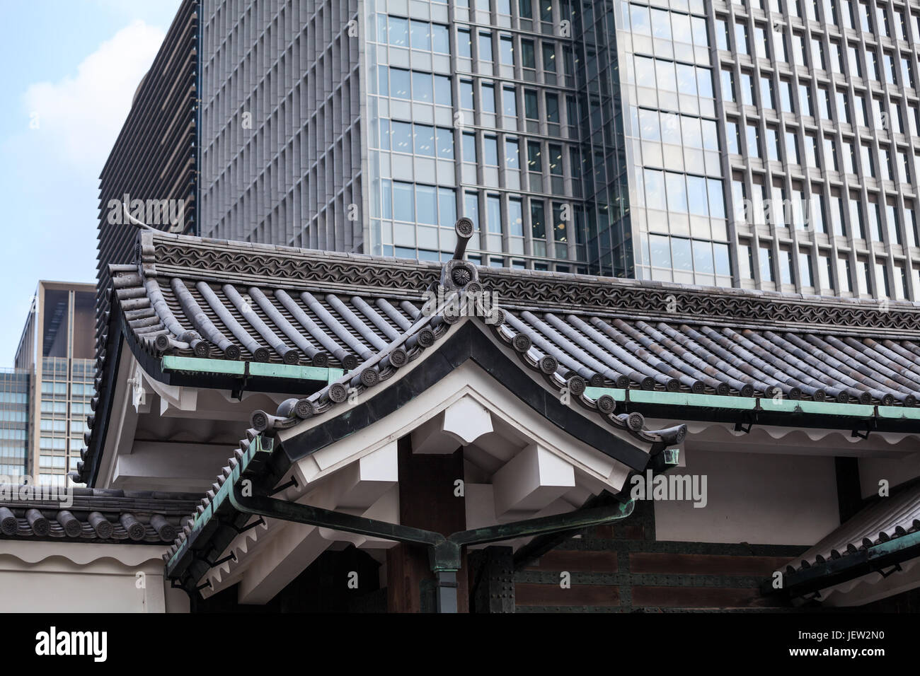 Tile ancient Japanese roofs against modern buildings in Tokyo city ...