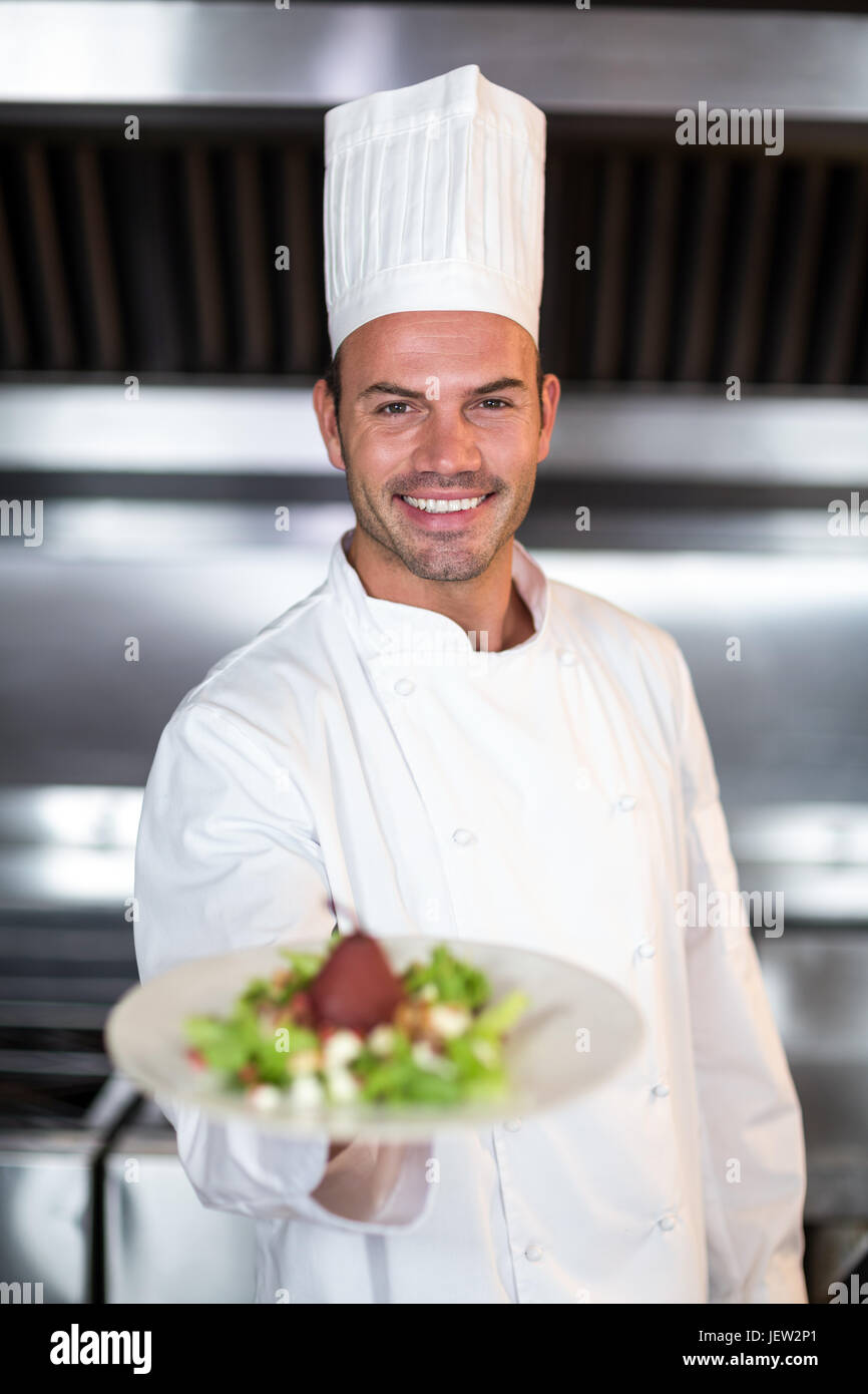 Male chef holding plate hi-res stock photography and images - Alamy