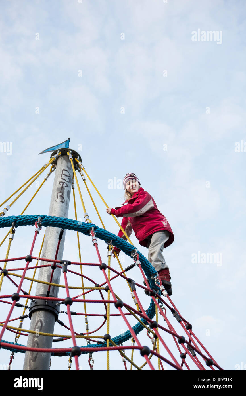 Girl climbing on playground Stock Photo - Alamy