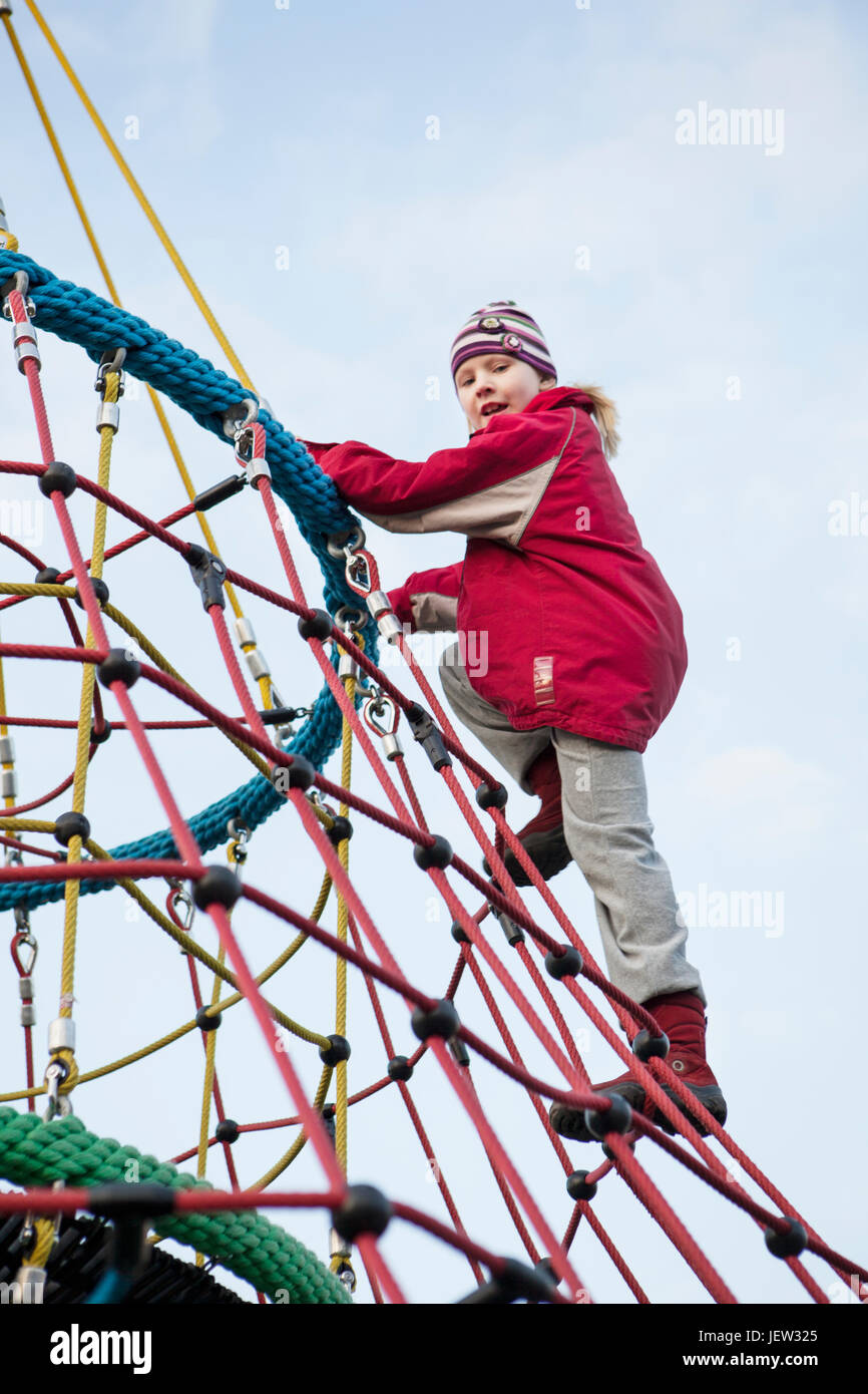 Girl climbing on playground Stock Photo - Alamy