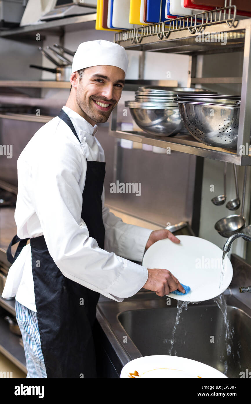 Handsome employee doing dishes Stock Photo - Alamy
