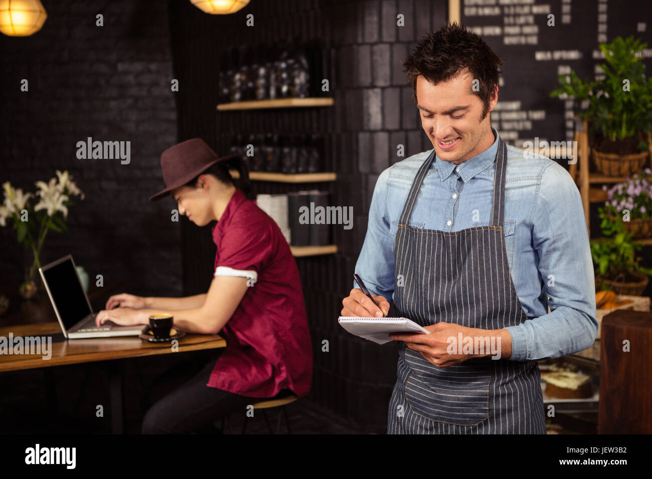 Waiter writing down the orders Stock Photo - Alamy