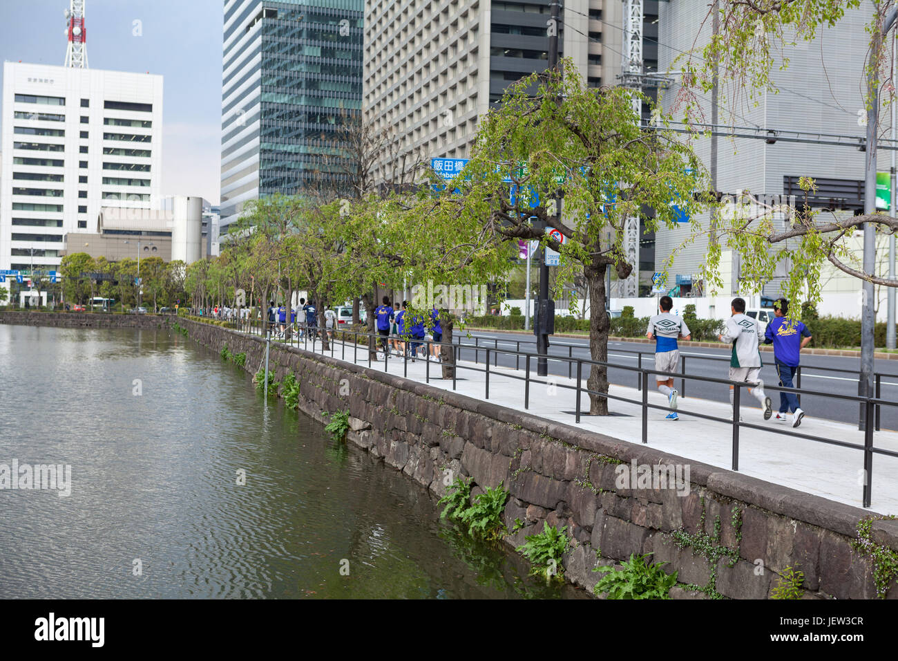 TOKYO, JAPAN - CIRCA APR, 2013: Japanese teenagers jog through the city ...