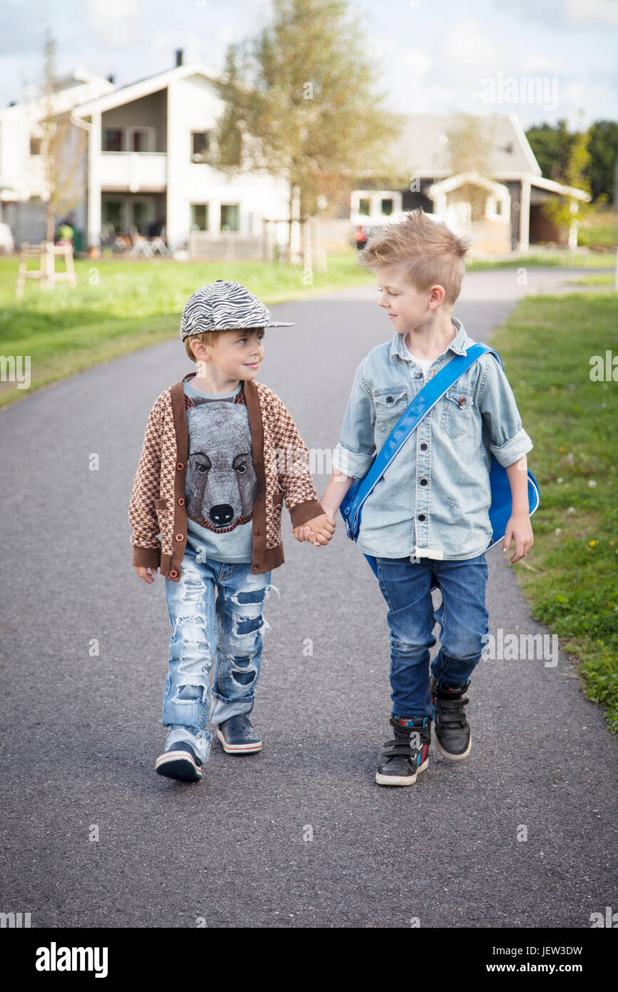 Two boys walking together school hi-res stock photography and images ...