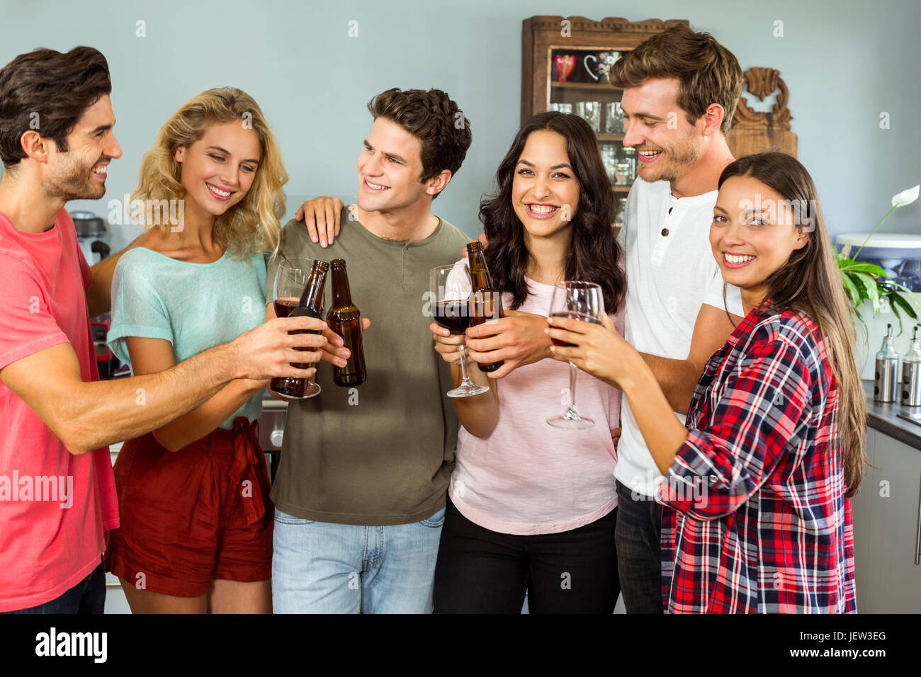 Happy friends toasting drinks at home Stock Photo - Alamy