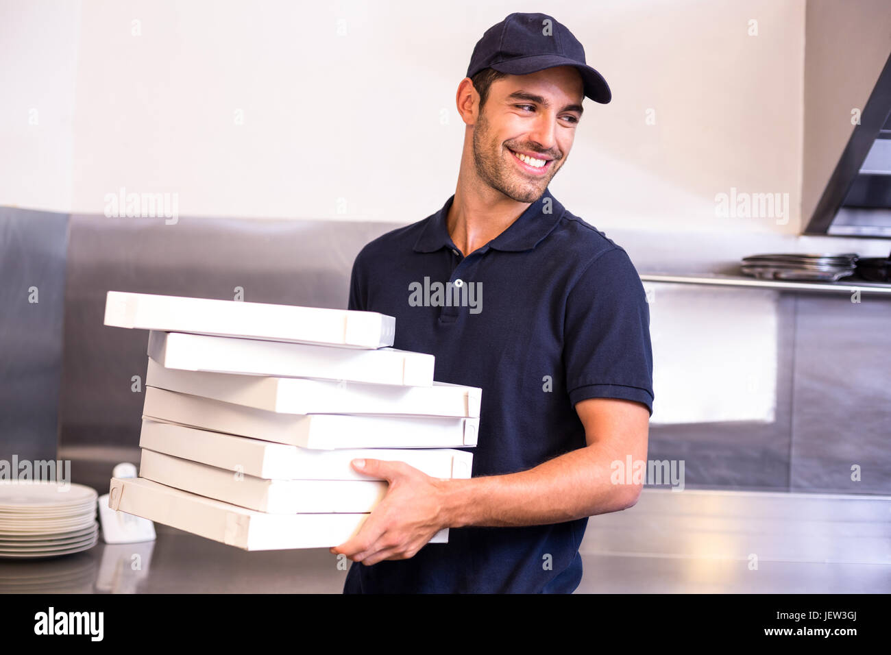 Pizza delivery man carrying boxes Stock Photo - Alamy