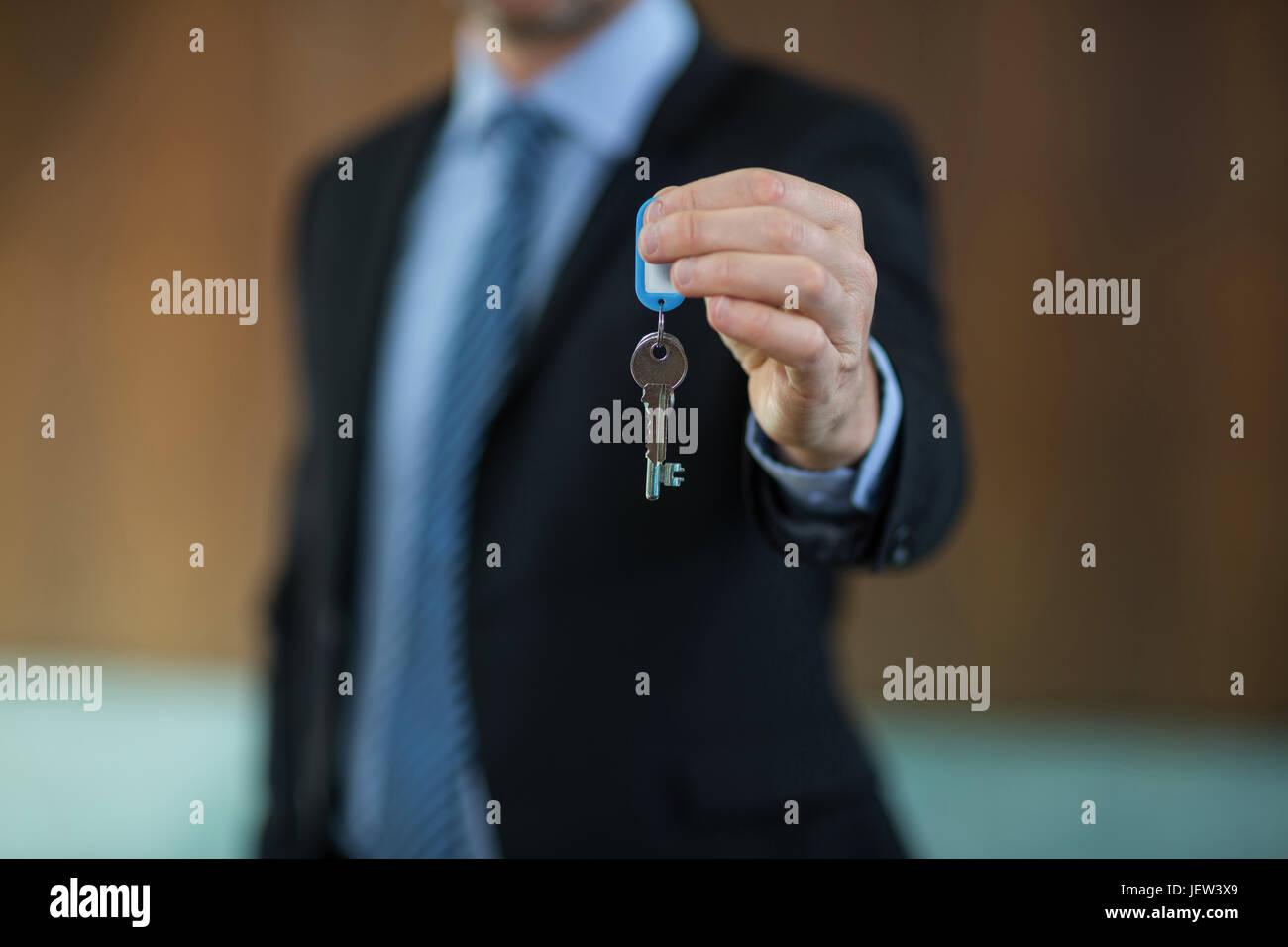 Real estate agent holding key Stock Photo - Alamy