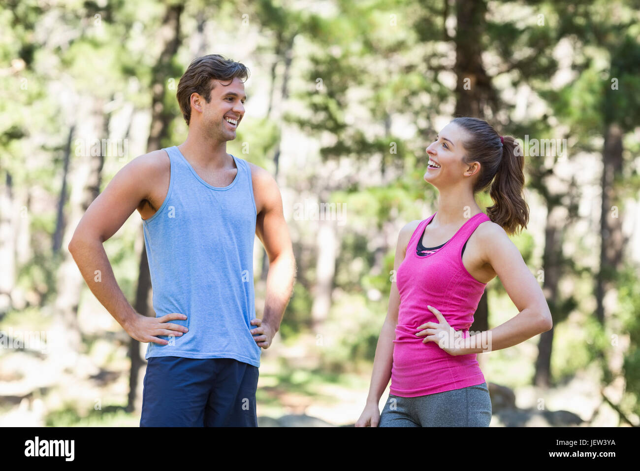 Happy joggers in forest Stock Photo - Alamy