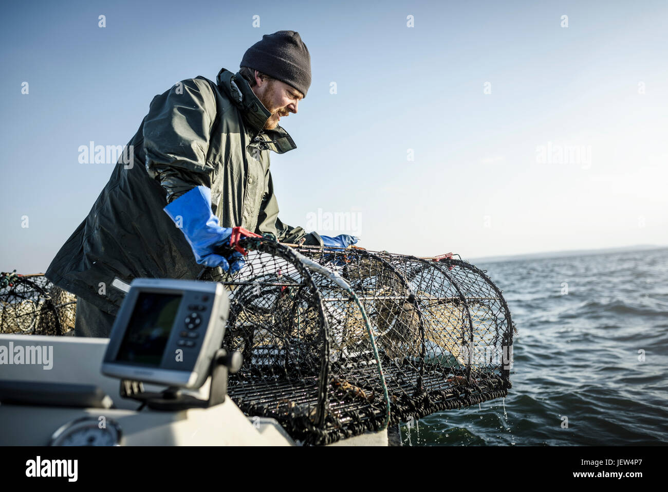 Fisherman with lobster trap Stock Photo - Alamy