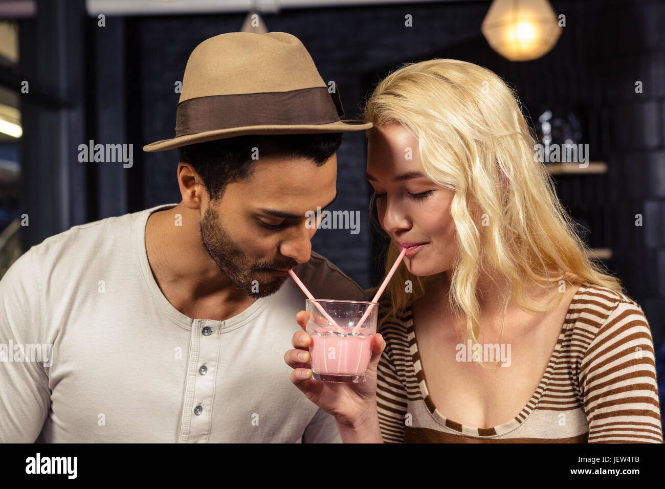 Couple sharing a milkshake Stock Photo - Alamy