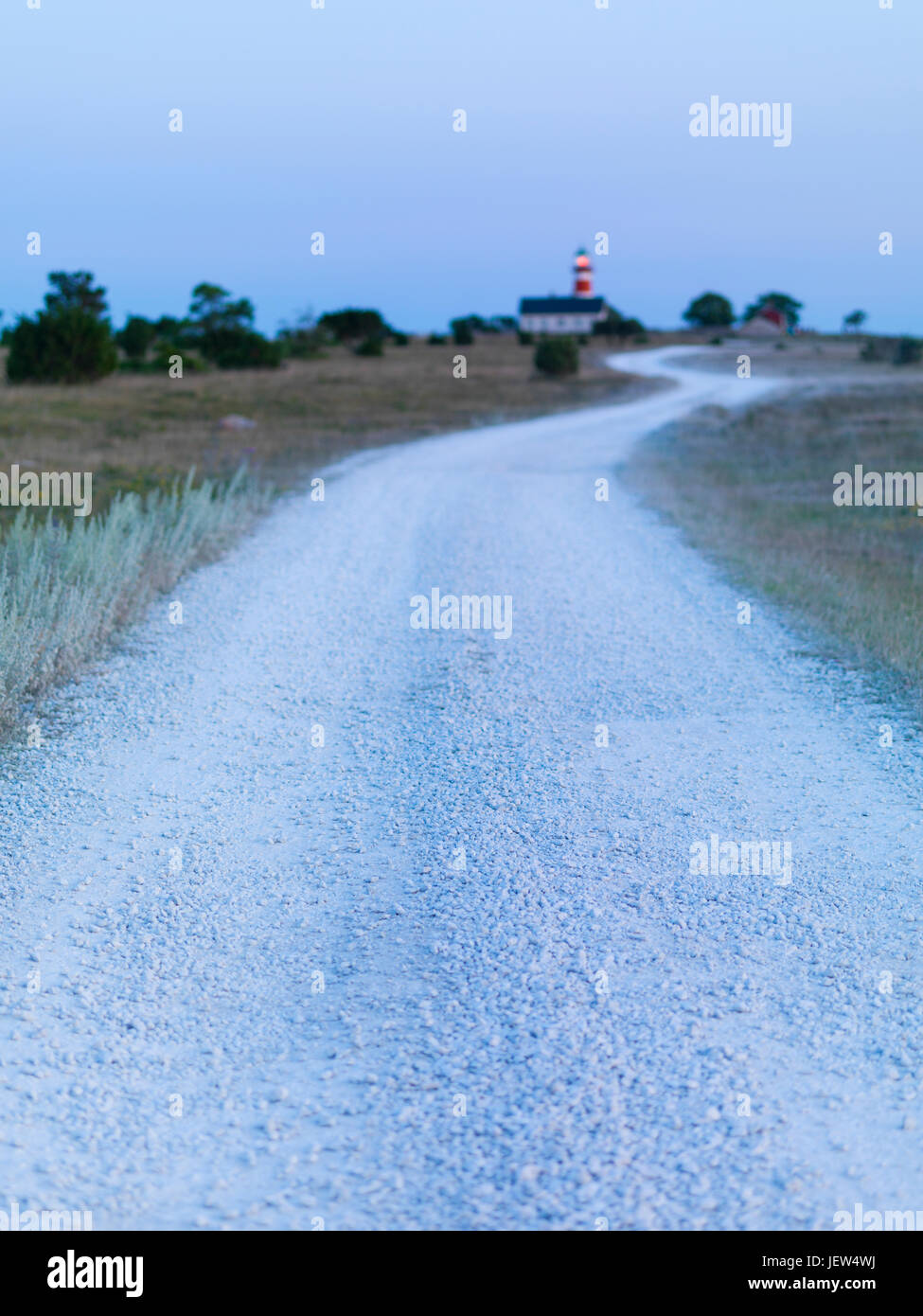 Dirt track, lighthouse on background Stock Photo - Alamy
