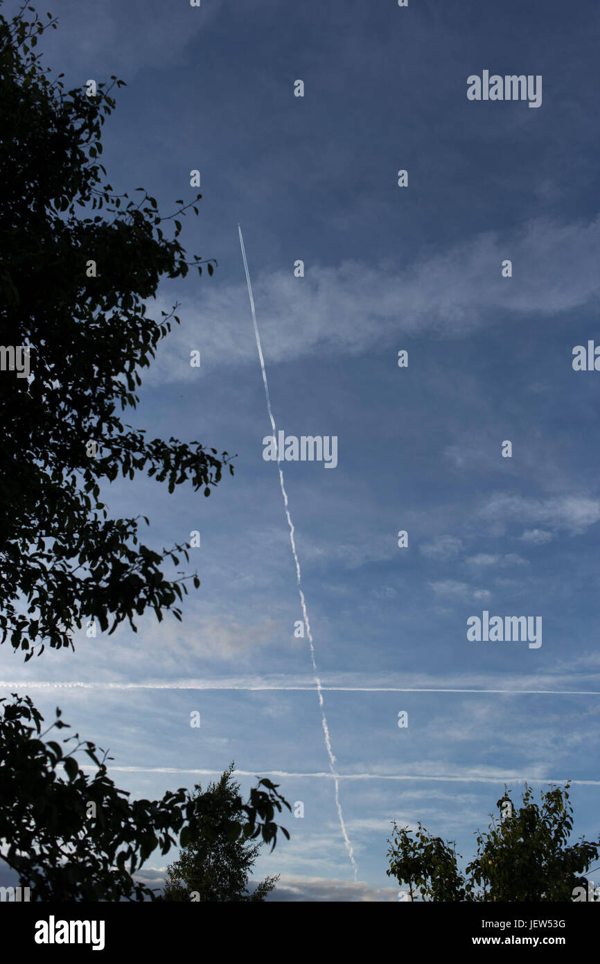 Traces of aircraft in the evening sky Stock Photo - Alamy