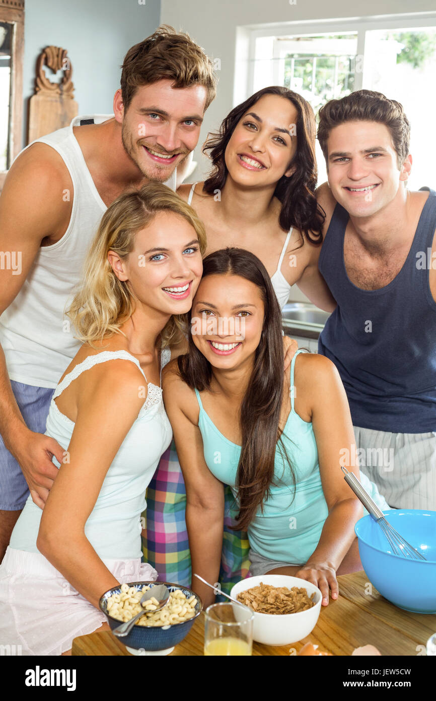 Happy young friends making breakfast at home Stock Photo - Alamy