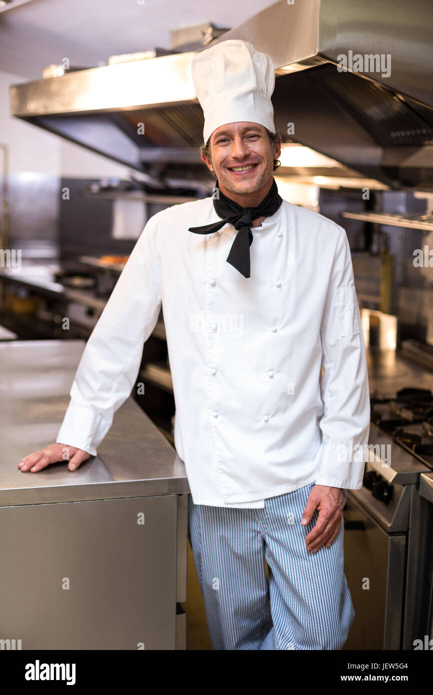 Handsome chef leaning on counter Stock Photo - Alamy