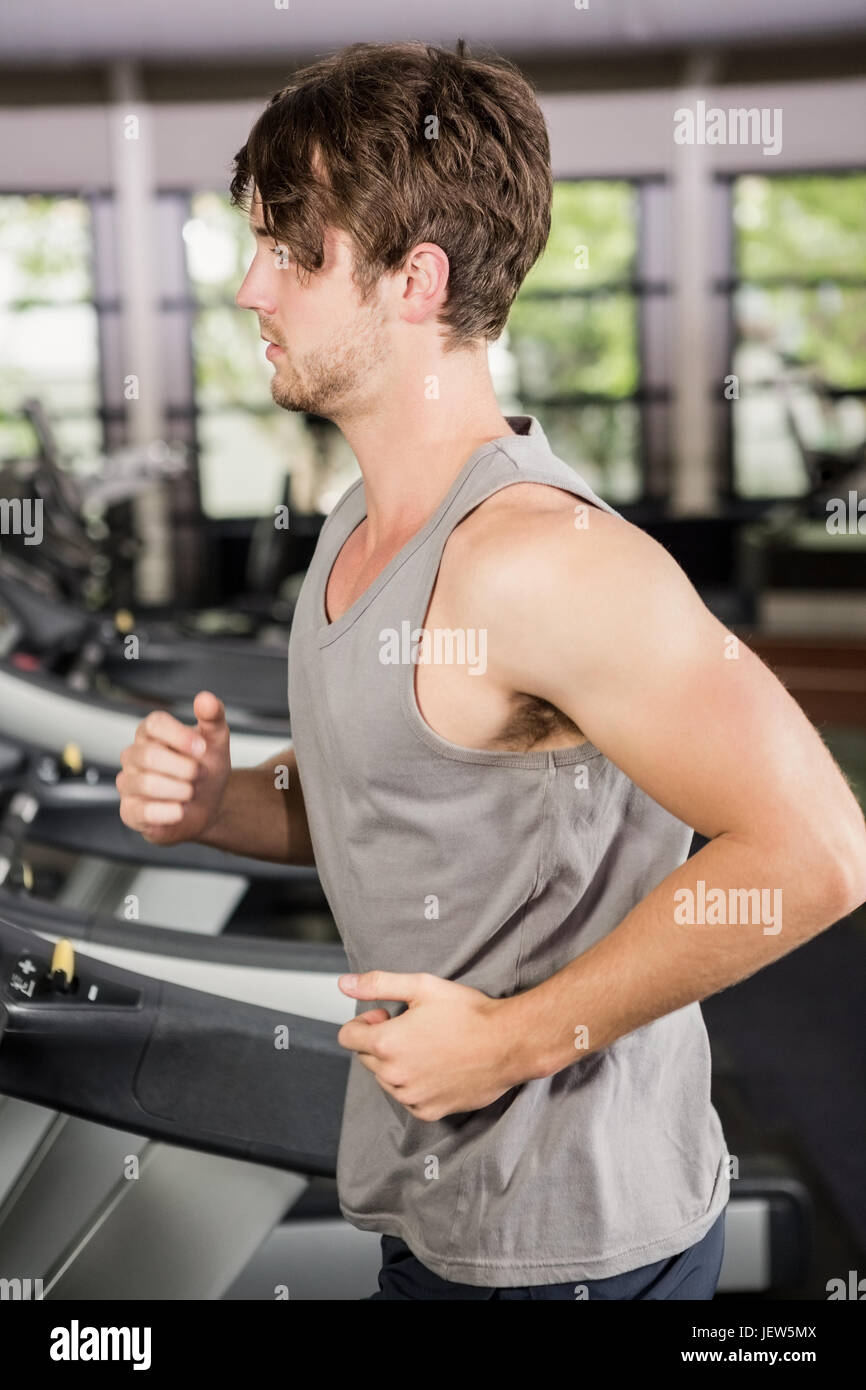 Man running on thread mill Stock Photo - Alamy