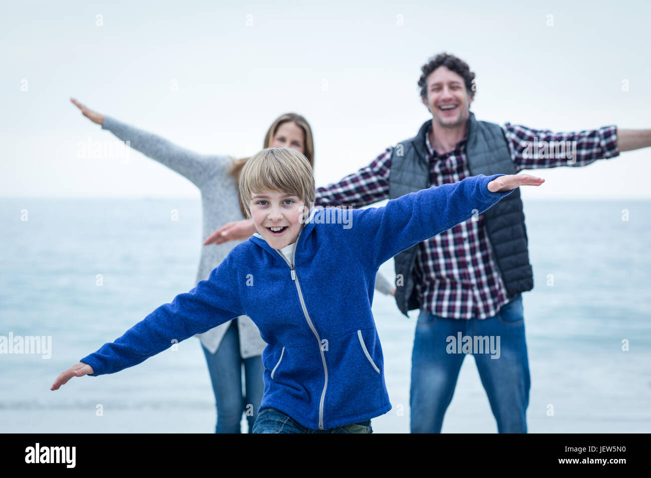 Boy enjoying wirth parents at beach Stock Photo - Alamy
