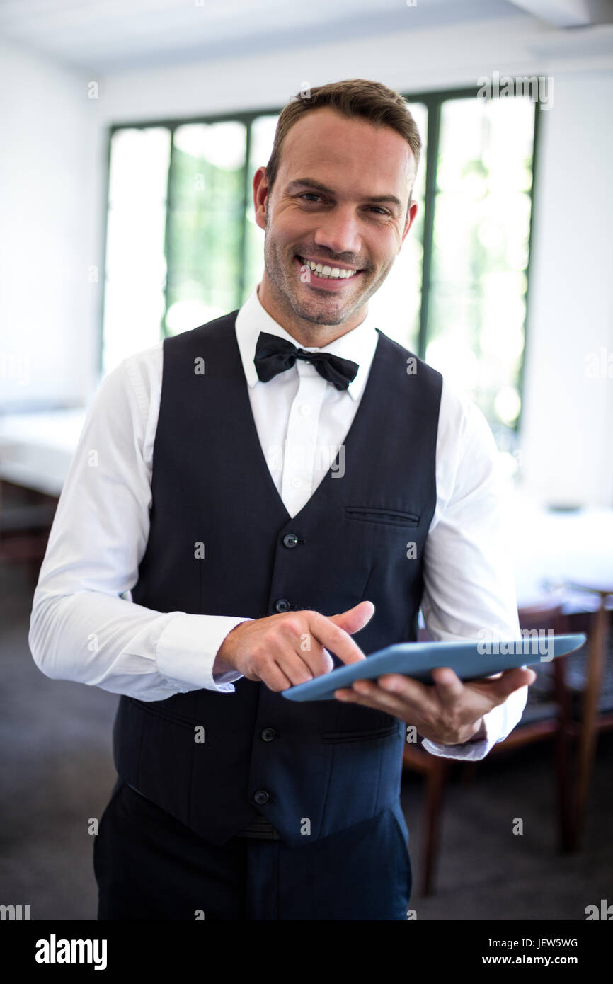 Waiter using digital tablet Stock Photo - Alamy