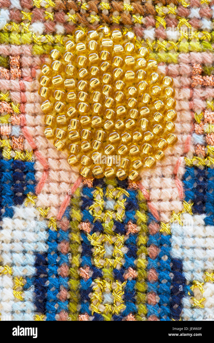 macro vertical image of a symmetrical embroidery showing a circle of ...