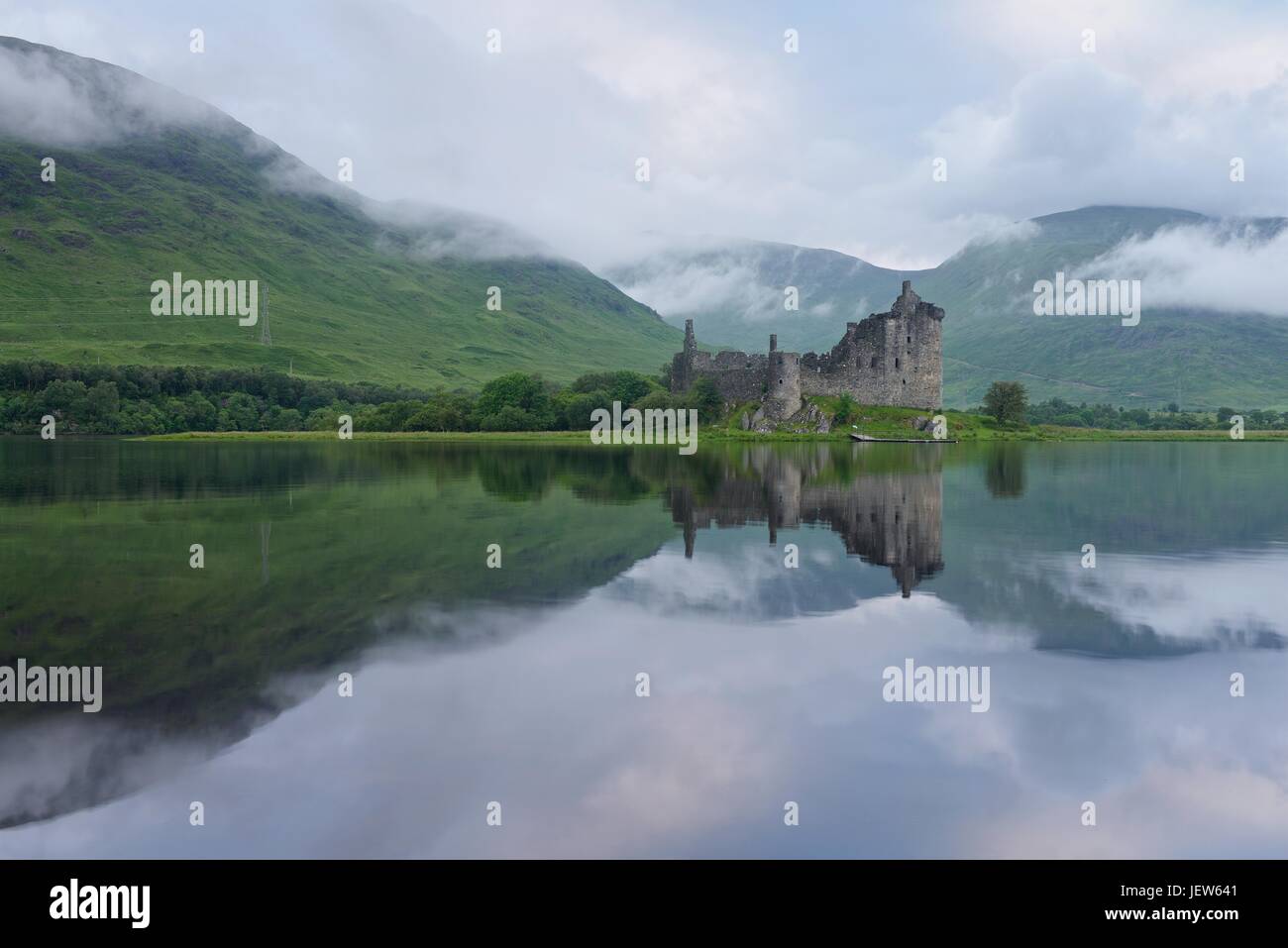 Reflections on an overcast morning of the ruins of Kilchurn Castle. The ...