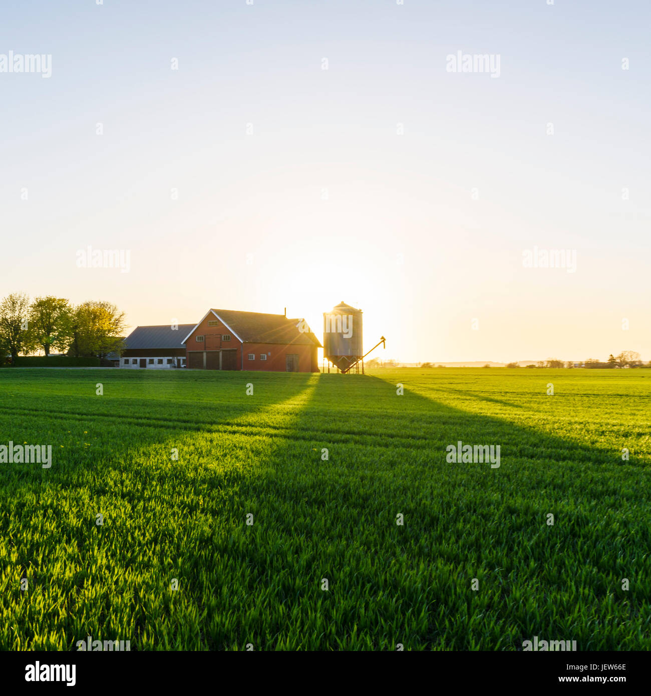 Green field and farmhouse Stock Photo - Alamy