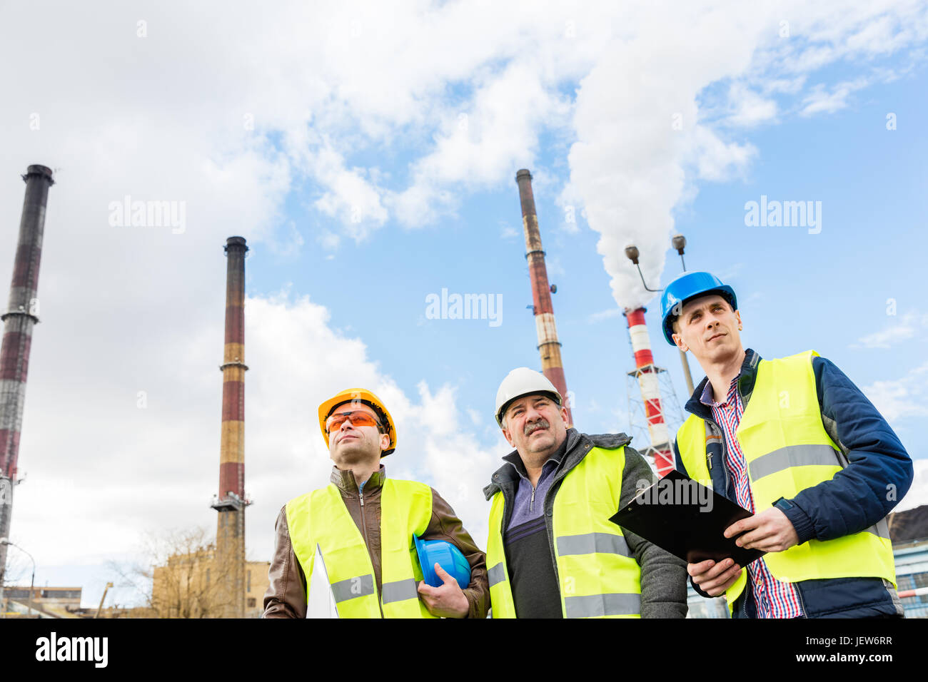 Construction engineers examining thermoelectric power station. Heat and ...
